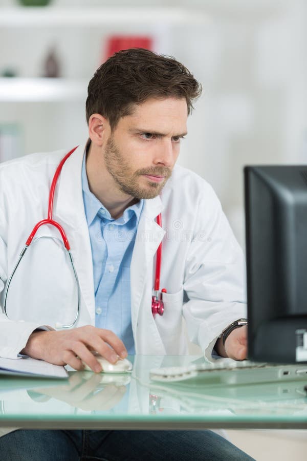 Male Doctor Working at Workplace Stock Photo - Image of uniform, clinic ...