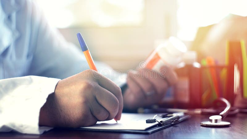 Male Doctor Writing Rx Prescription Stock Photo - Image of clinic ...
