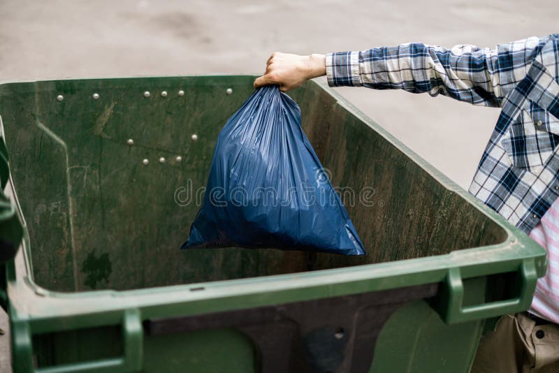 Male Dumping Waste Package into a Big Trash Bin Containers Stock Image ...