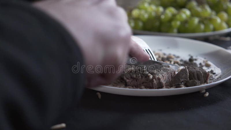 Male Eagerly Cuts a Cooked Meat with a Knife, on Which Disgusting ...