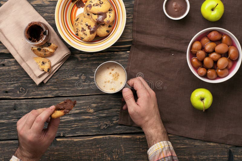 Male Eating Breakfast of Chocolate Cookies with Coffee Stock Photo ...