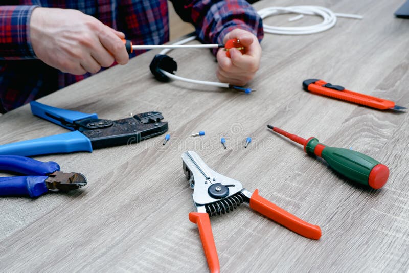 A Male Electrician Changes the Plug on an Electric Wire. Working with ...