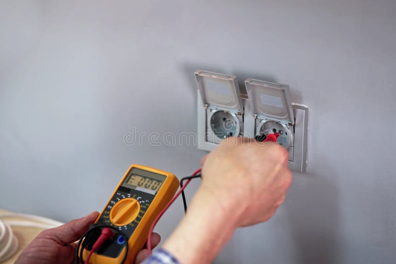 Male Electrician Checking Voltage of Socket with Multimeter Stock Image ...