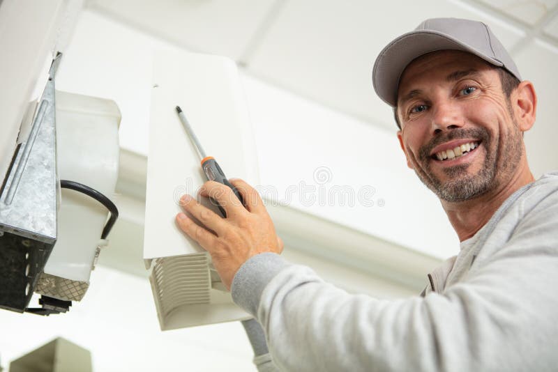 Male Electrician Installing Electrical Device on Wall Stock Image ...