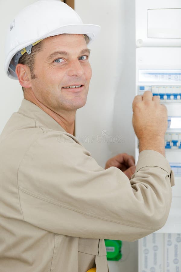 Male Electrician Stood by Circuit Breaker Box Stock Photo - Image of ...