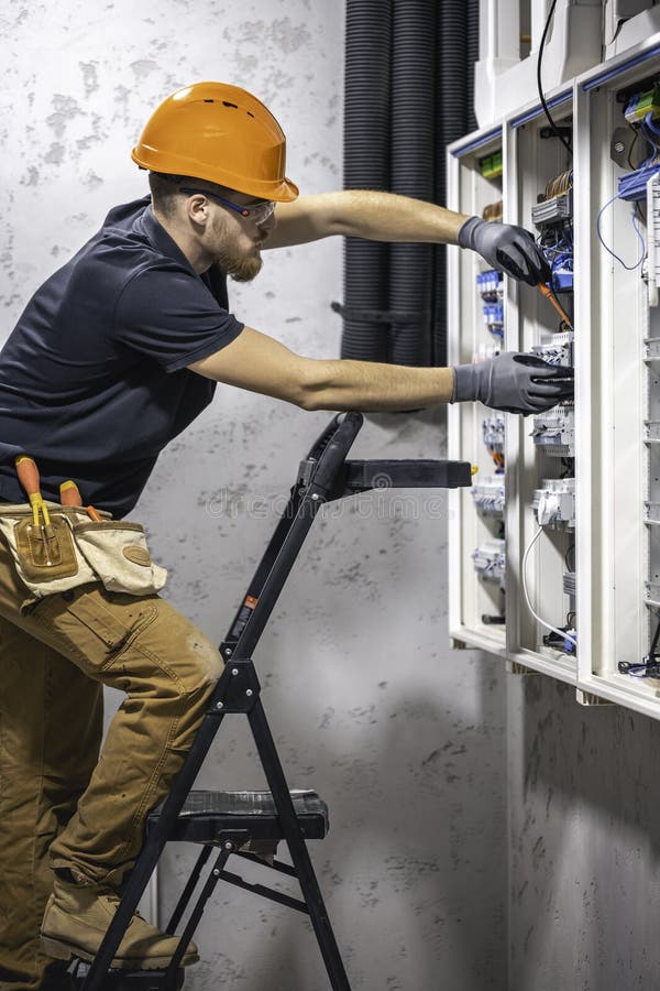 Male Electrician Working in a Switchboard with Fuses. Stock Photo ...