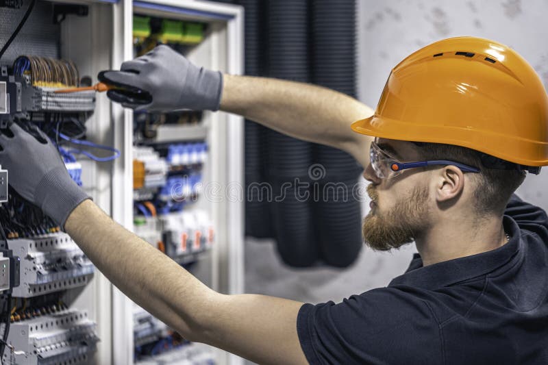Male Electrician Working in a Switchboard with Fuses. Stock Photo ...