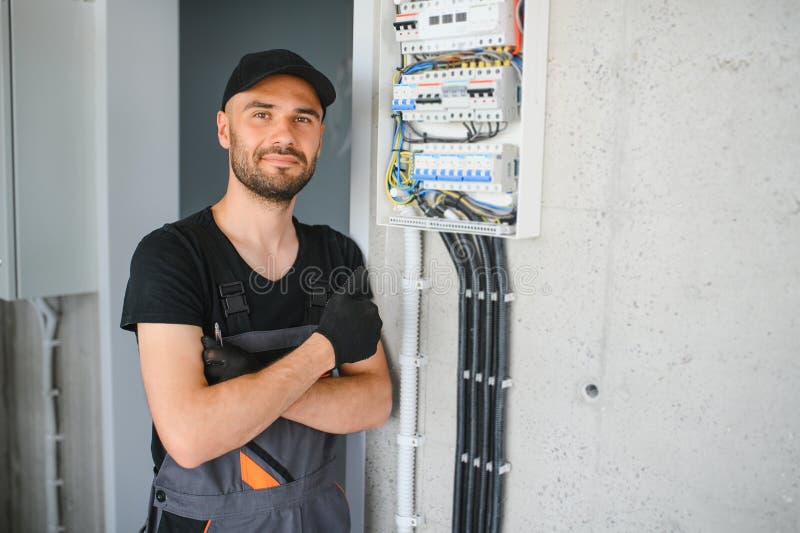 A Male Electrician Works in a Switchboard Stock Image - Image of ...