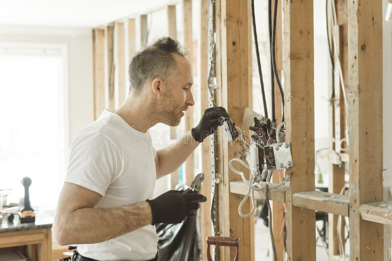 An Electrician Male Working on Basement Bulb Stock Photo - Image of ...