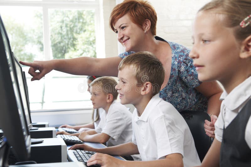 Girls Using Computers in Class with Teacher Stock Image - Image of ...