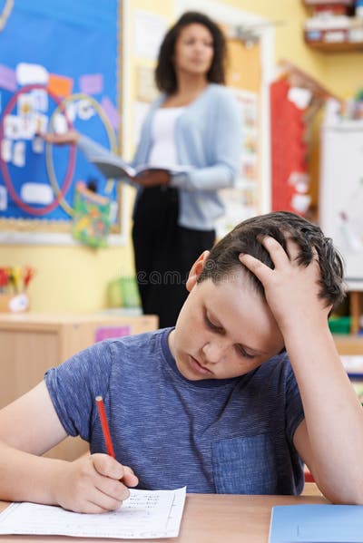 Male Elementary School Pupil Struggling in Class Stock Image - Image of ...