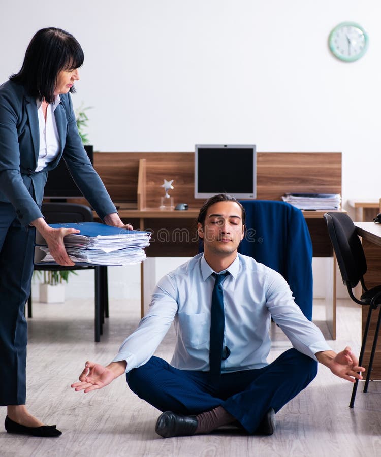 Male Employee Doing Yoga Exercises in the Office Stock Photo - Image of ...