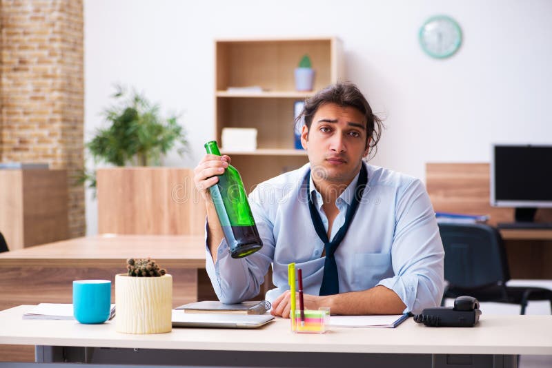 Young Male Employee Drinking Alcohol at Workplace Stock Photo - Image ...