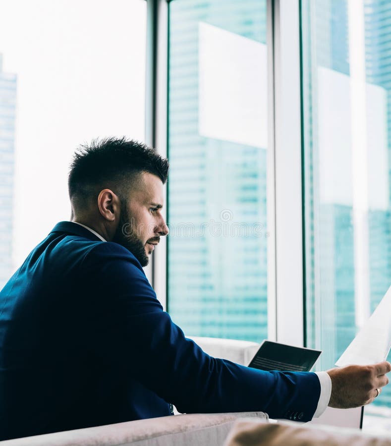 Male Employee in Formal Wear Reviewing Documents at Office Stock Photo ...
