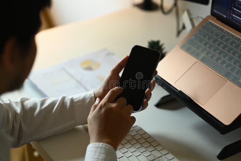 Male Employee Sitting at Desk and Using Mobile Phone Reading Text ...