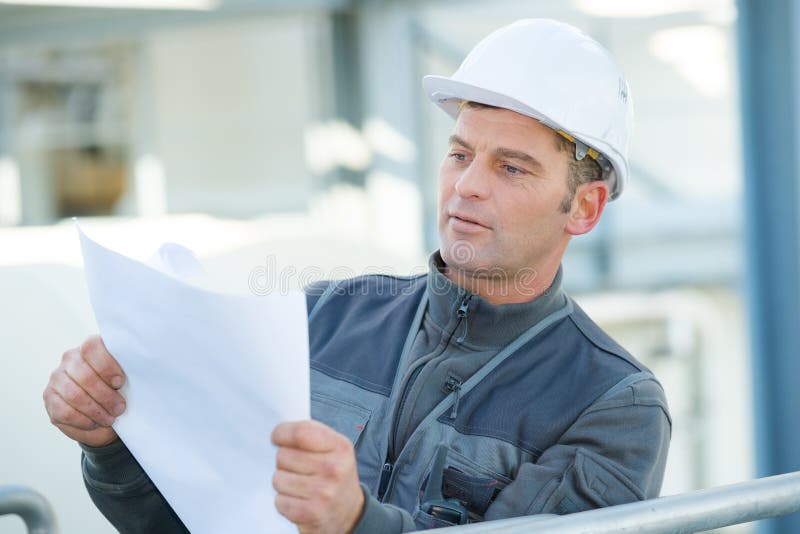 Male Engineer Checking Paper Work Stock Photo - Image of architect ...