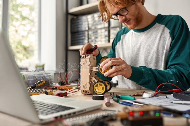 Male it Engineer Checking Wheel Robot at Table Stock Image - Image of ...