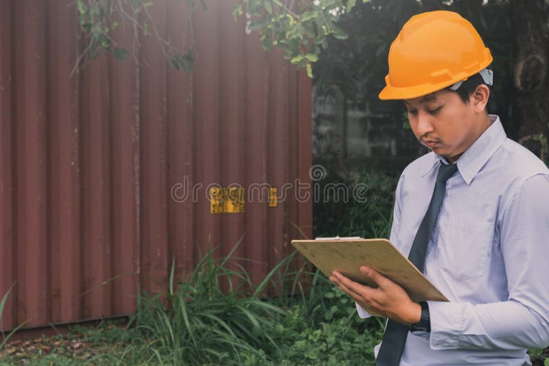 Male Engineer Inspection Checking on Container Background with Note on ...