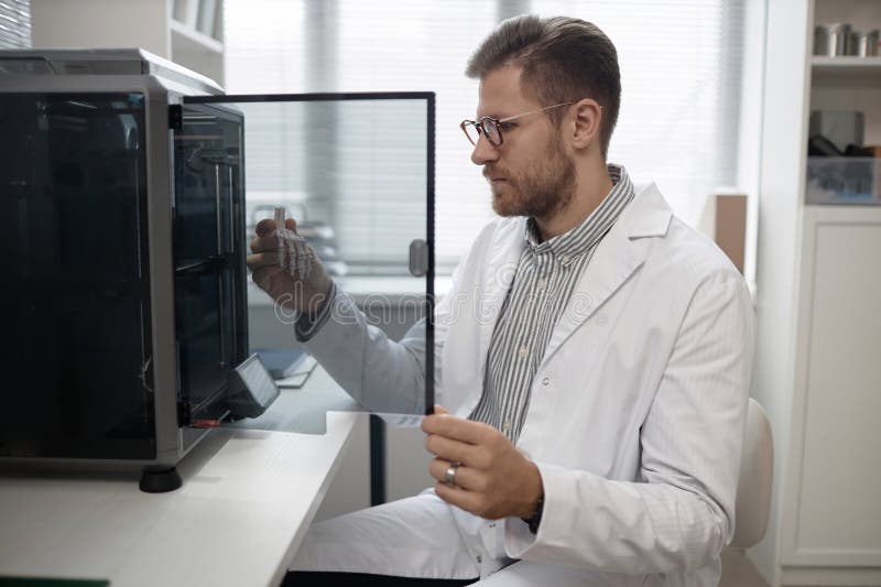 Male Engineer Looking at 3D Bone Model Stock Photo - Image of chamber ...