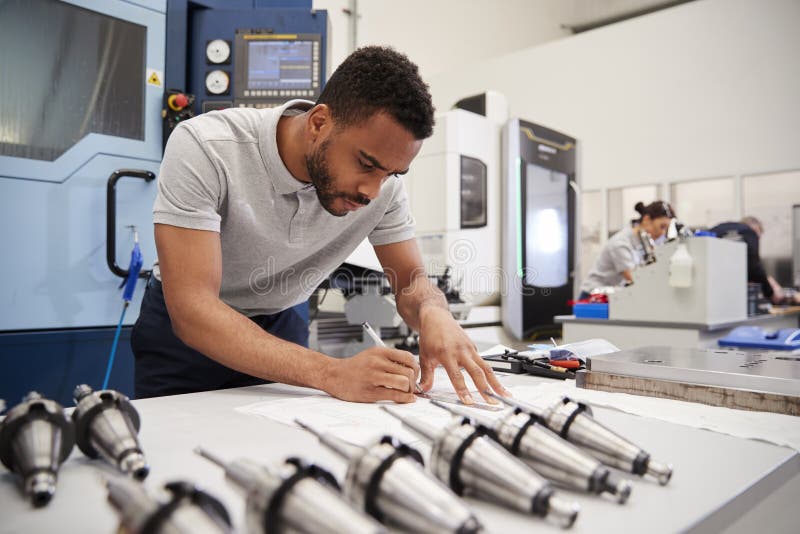 Male Engineer Measuring CAD Drawings in Factory Stock Image - Image of ...