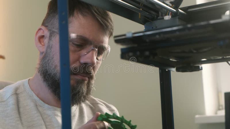 Male Engineer in a Modern Home Office Observing the Printing Process of ...