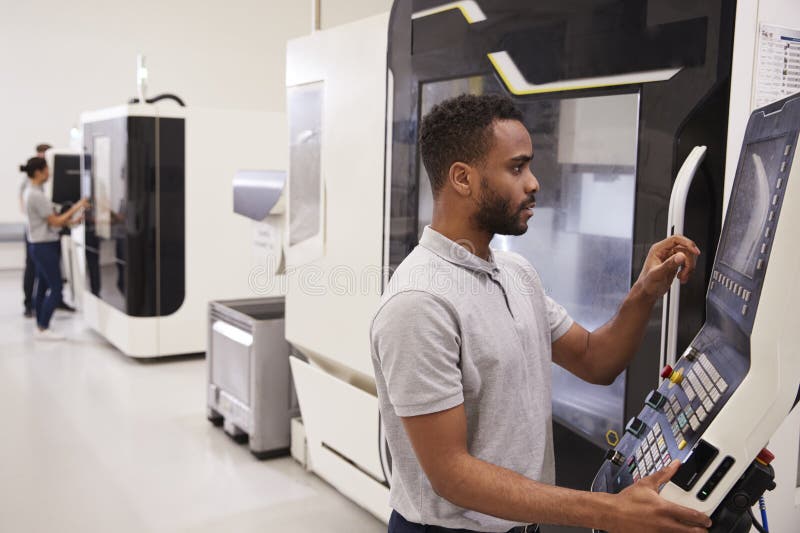 Male Engineer Operating CNC Machinery in Factory Stock Image - Image of ...
