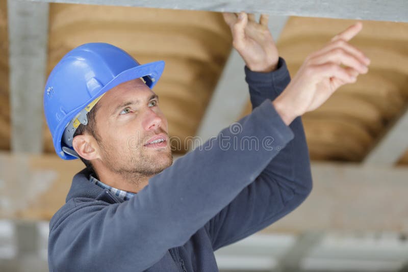 Male Engineer Pointing at Ceiling Stock Photo - Image of decorating ...