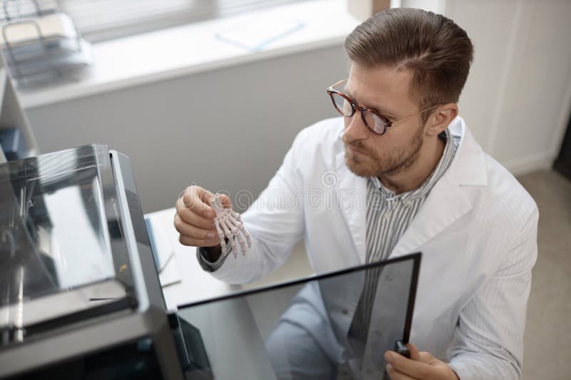 Male Engineer with Printed 3D Bone Model in Hand Stock Photo - Image of ...