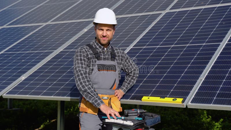 Male Engineer in Protective Helmet Installing Solar Photovoltaic Panel ...