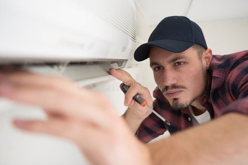 Male Engineer Repairing Wall Mounted Air Conditioning Unit Stock Image ...