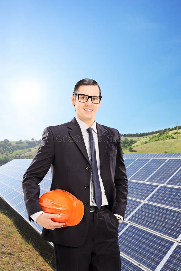 Male Engineer Standing in a Field with Solar Panels Stock Photo - Image ...