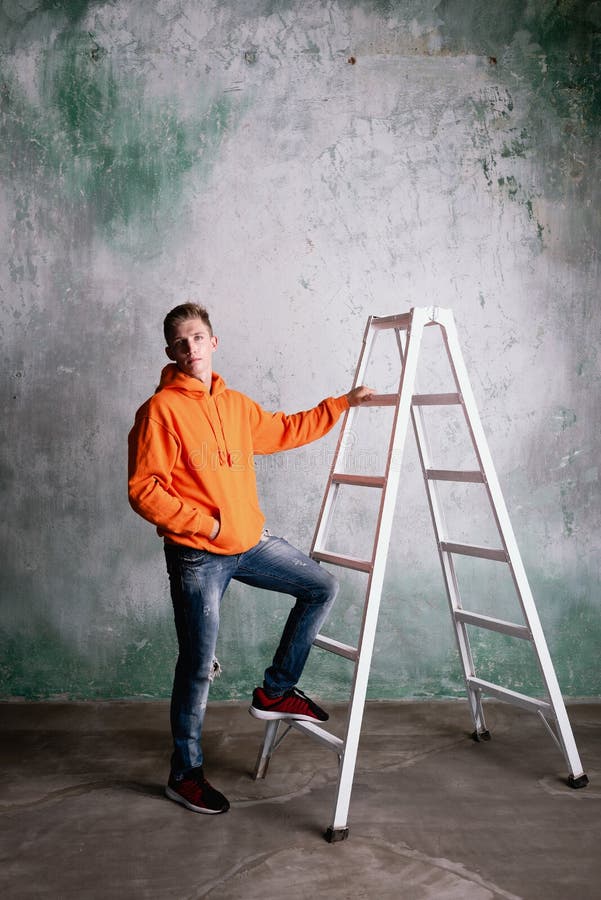A Male Engineer Stands on a Building Ladder. Work Clothes Stock Image ...