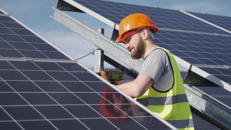 Male Engineer in a Uniform is Checking the Solar Battery Outside Stock ...