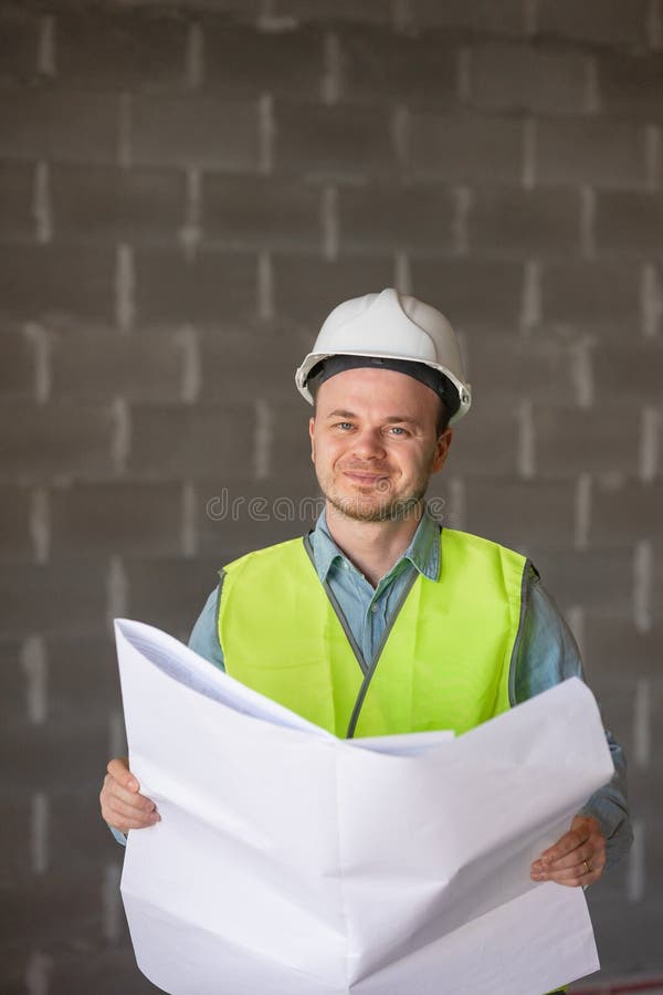 Male Engineer in White Helmet Holds Plan of Object in His Hands ...