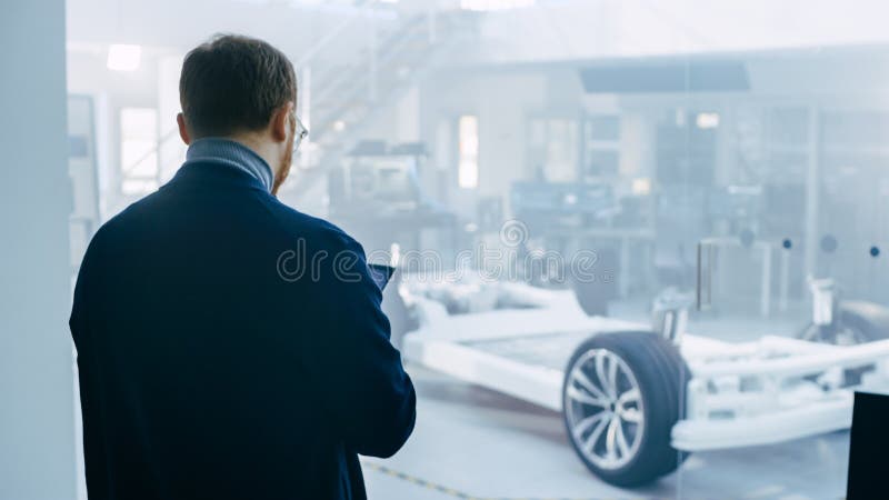 Male Engineer is Working in a High Tech Development Facility Holding a ...