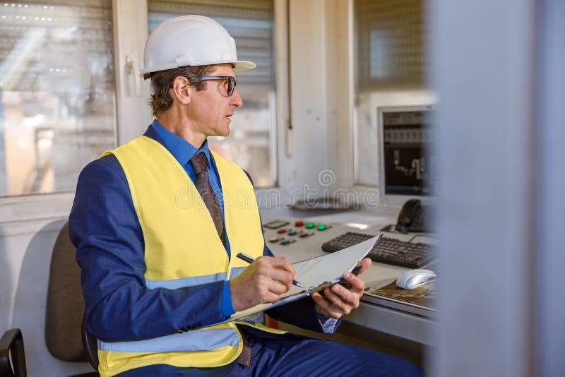 Male Engineer Writing Documents at Manufacturing Plant Stock Photo ...