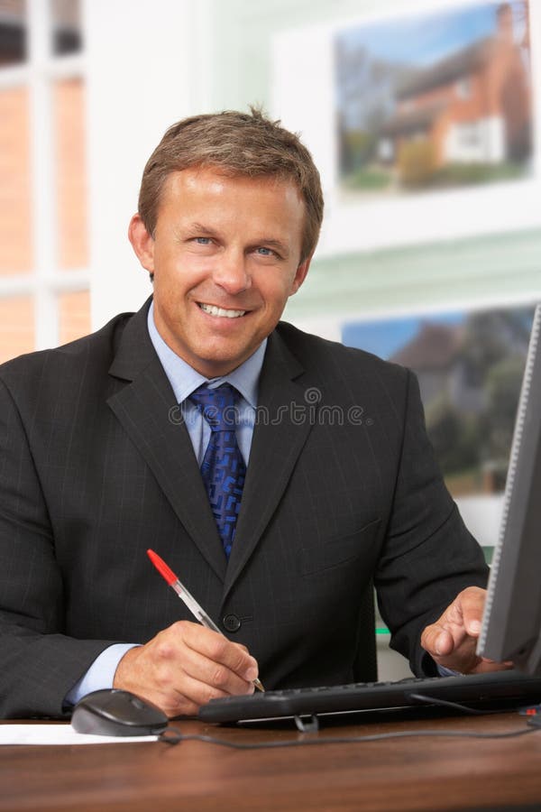 Male Estate Agent Talking on Phone at Desk Stock Image - Image of ...
