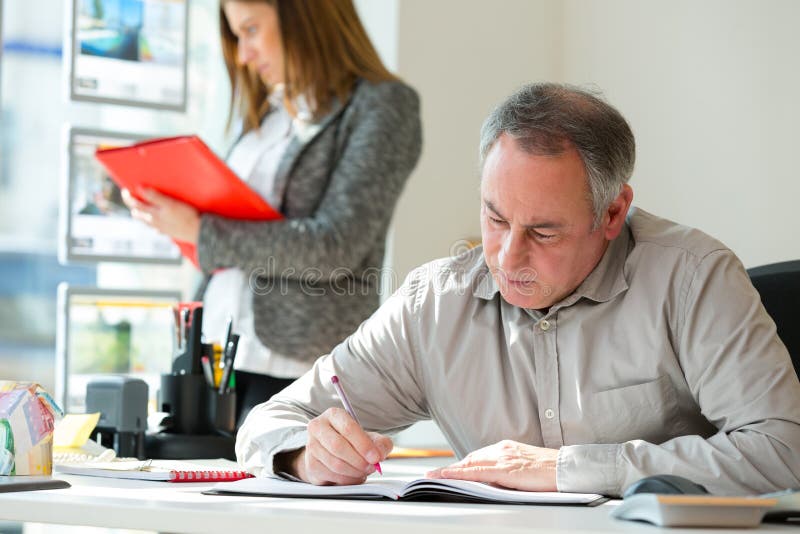 Male Estate Agent Working at Office Desk Stock Photo - Image of person ...