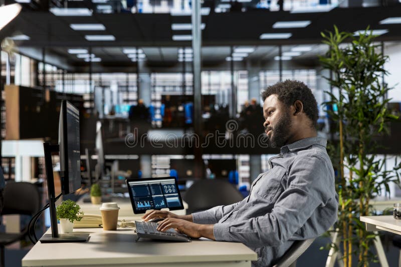 Male Executive Analyst Finalizes a Financial Report and Reviews Data ...