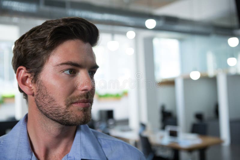 Male Executive Looking Away in the Office Stock Photo - Image of ...