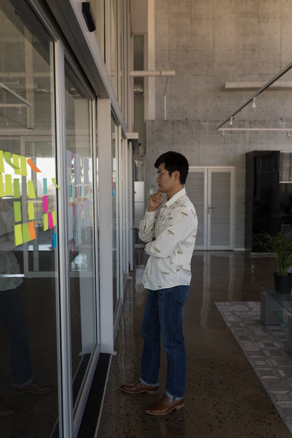 Male Executive Looking at Chart in Office Stock Photo - Image of ...