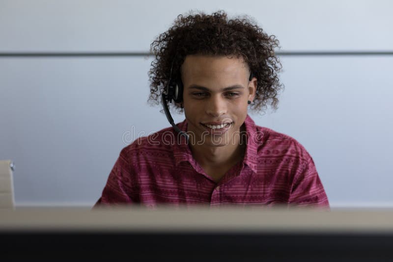 Male Executive Talking on Headset in Office Stock Image - Image of ...