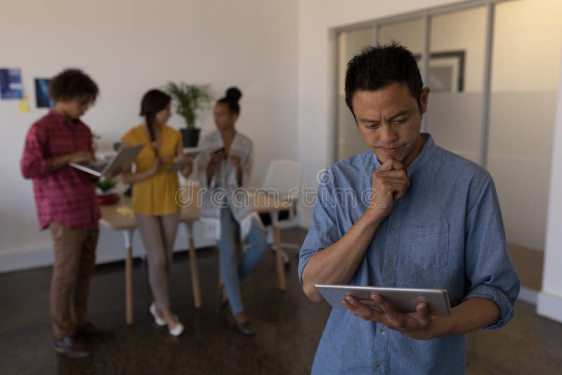 Male Executive Using Digital Tablet in Office Stock Photo - Image of ...