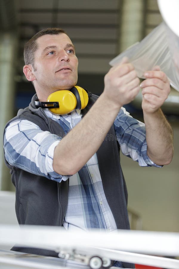 Male Factory Worker Pulling Length Plastic Film Stock Photo - Image of ...