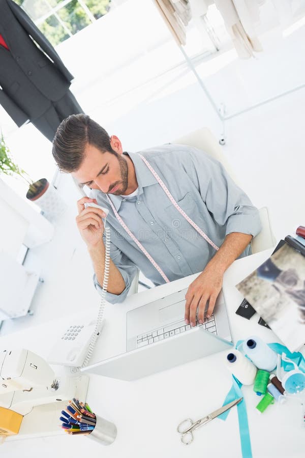 Smiling Young Male Fashion Designer Using Laptop Stock Photo - Image of ...