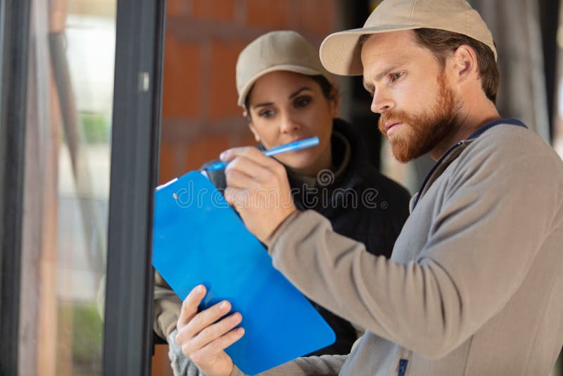 Male Female Builder Reviewing Instructions on Site Stock Photo - Image ...