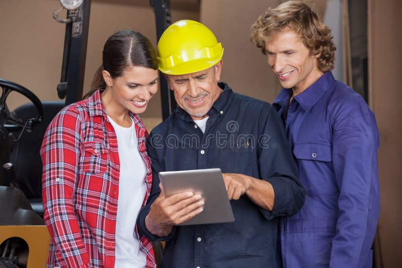 Male and Female Carpenters Using Digital Tablet Stock Photo - Image of ...