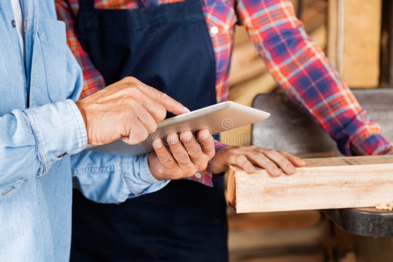 Male and Female Carpenters Using Digital Tablet Stock Image - Image of ...