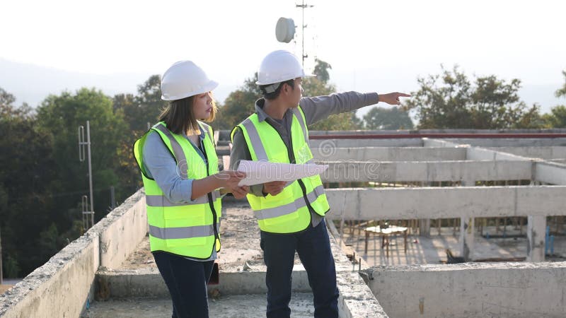 Male and Female Civil Engineers Inspect and Analyze Projects Under ...