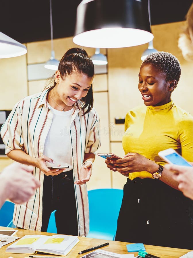 Male and Female Colleagues Talking about Internet Website in Office ...